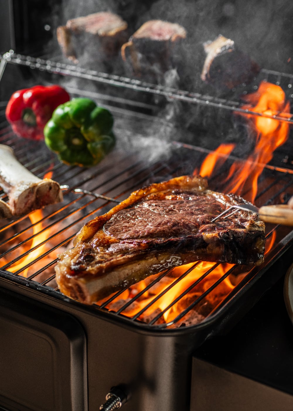Charcoal smoker barbecue with adjustable grate and folding side table ...